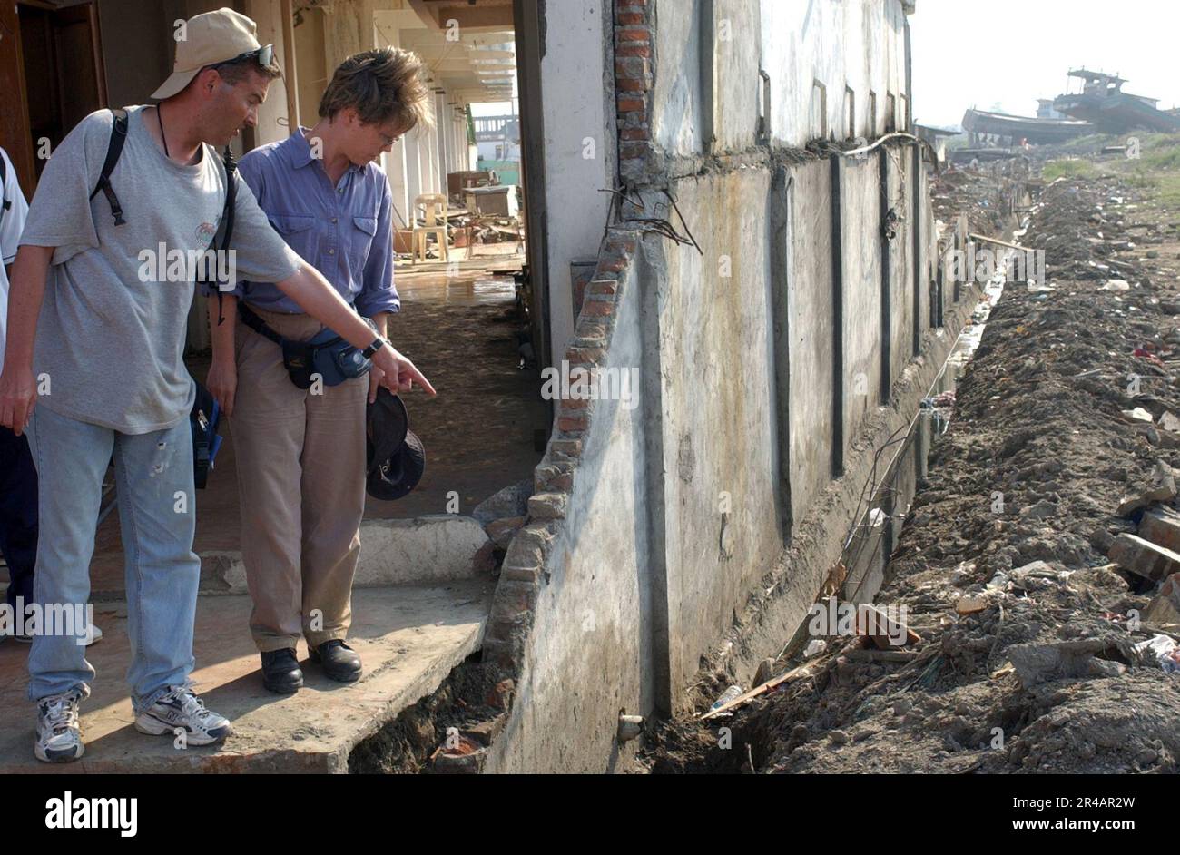 US Navy Hospital Corpsman 1st Class left, and Lt.j.g. inspect a water ...