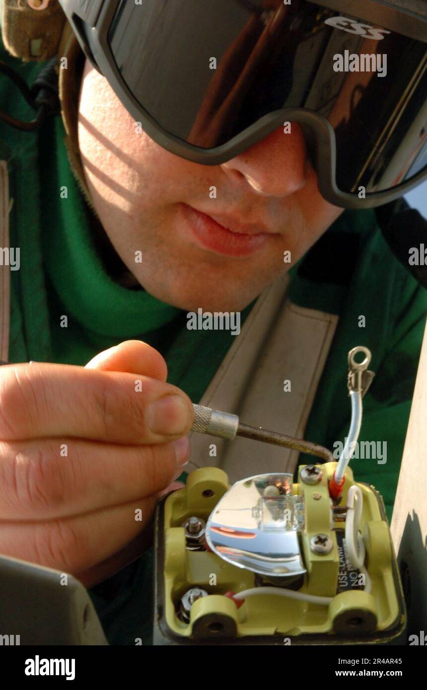 US Navy Aviation Structural Mechanic 2nd Class repairs a wing tip ...