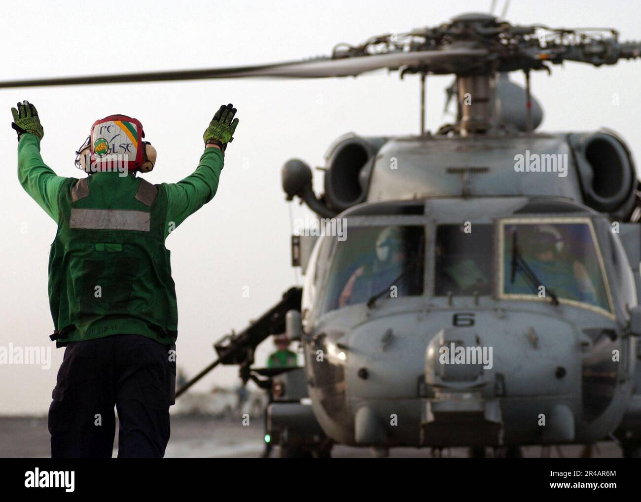 US Navy A Landing Signalmen Enlistedman (LSE) signals an HH-60H Seahawk ...