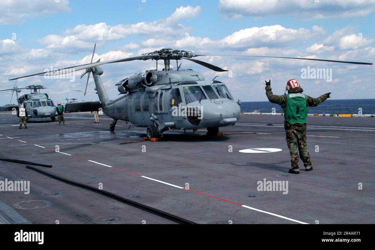 US Navy Aviation Maintenance Administrationman Airman directs the crew ...