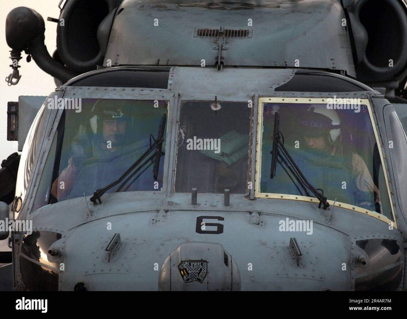 US Navy Pilots prepare their HH-60H Seahawk helicopter to lift off from the flight deck of the ...