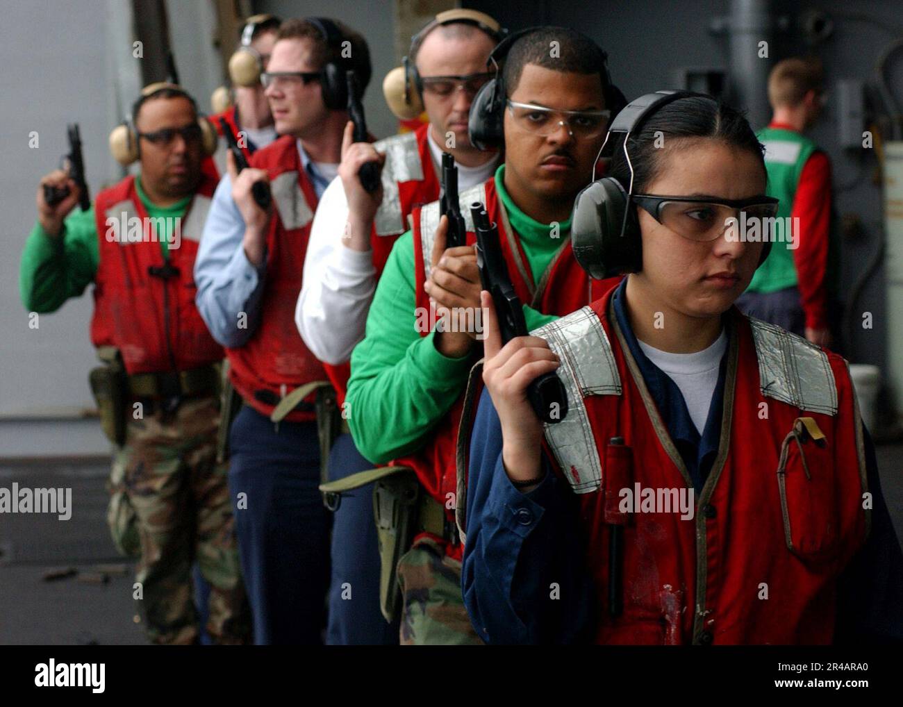 US Navy Photographer's Mate 3rd Class right, leads a group of Sailors ...