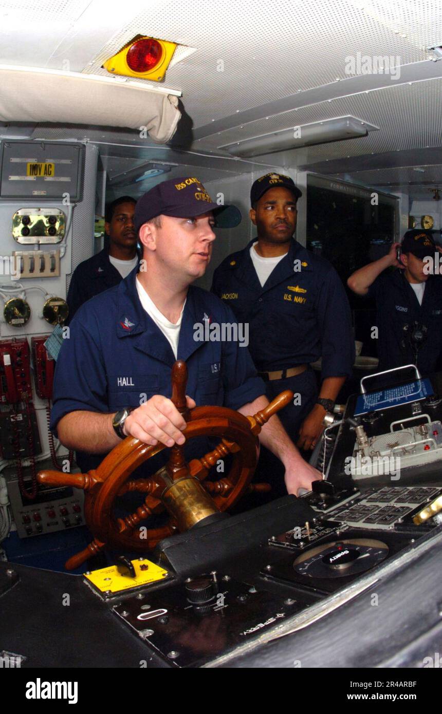 US Navy Quartermaster 3rd Class makes course corrections while steering ...