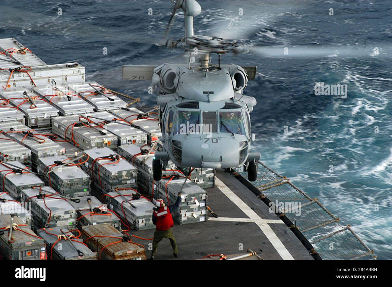 US Navy An MH-60S Seahawk lifts ordnance from the flight deck of the Military Sealift Command ...