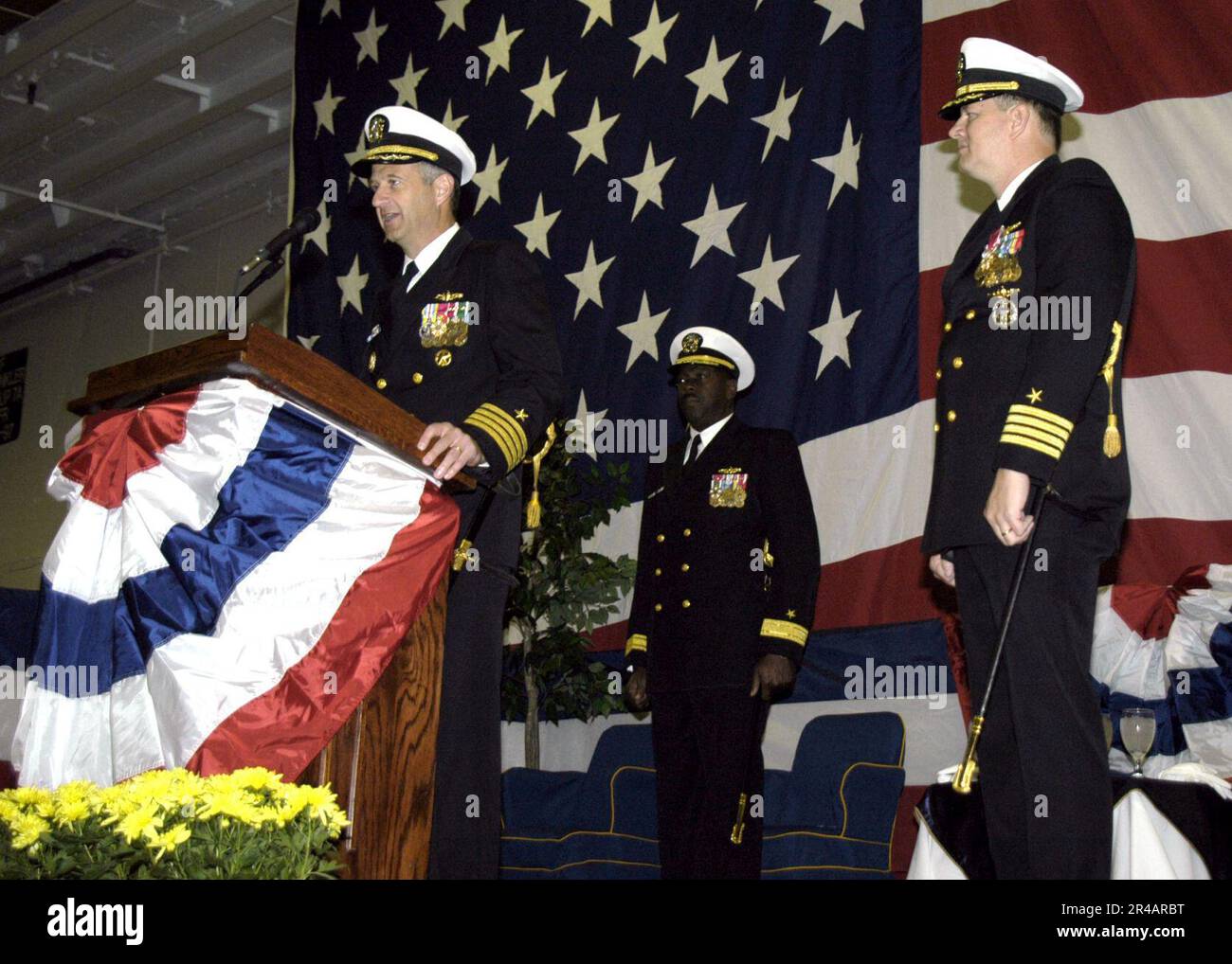 US Navy Capt. speaks to guests and crew at the change of command ...