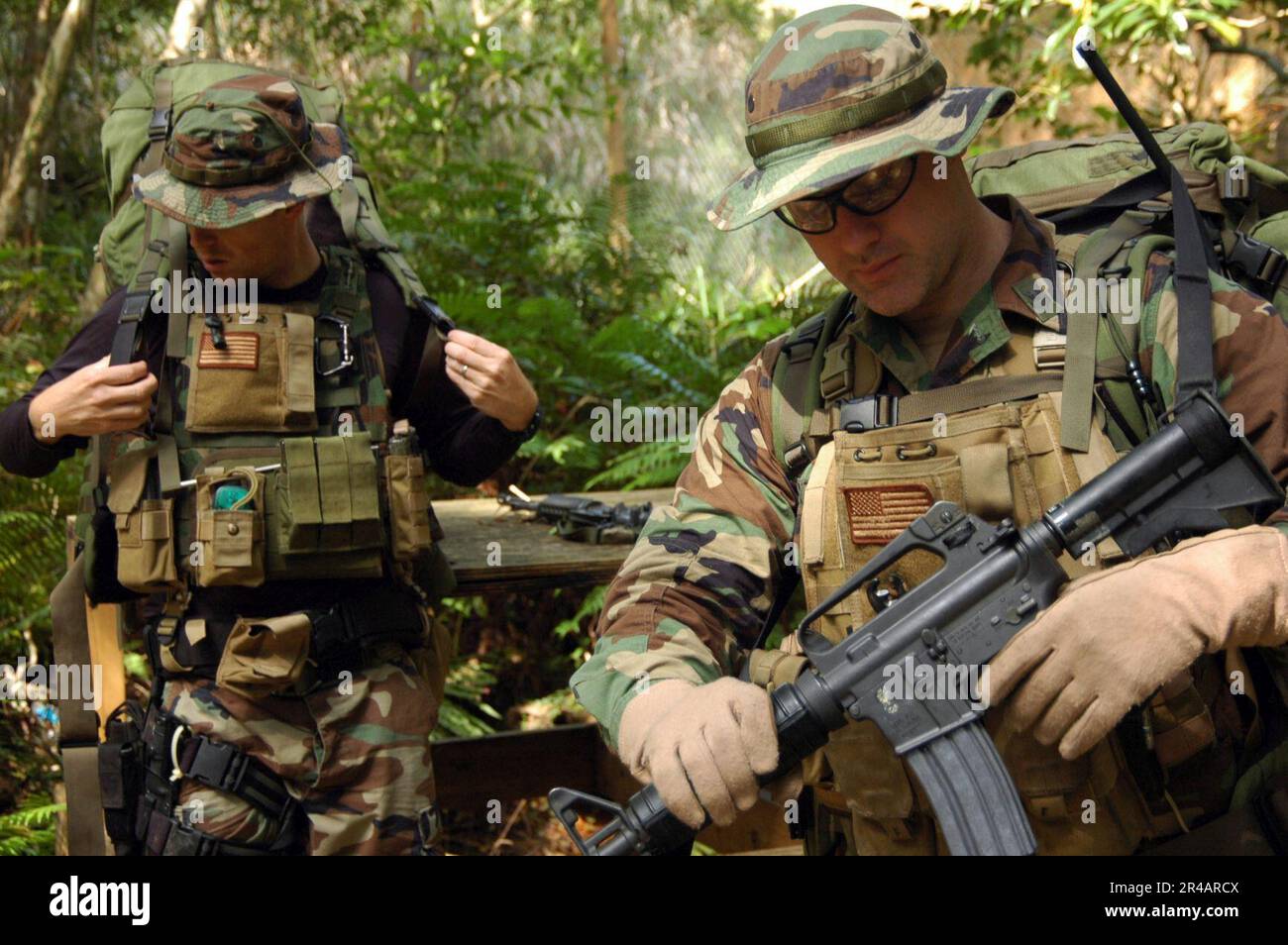 US Navy Aviation Ordnanceman 1st Class right, assigned to Explosive ...