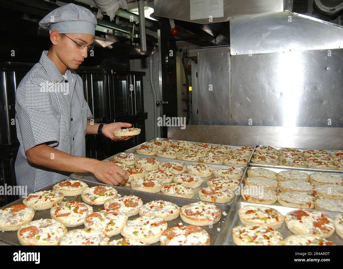 US Navy Culinary Specialist 3rd Class prepares pizza for the crew Stock ...
