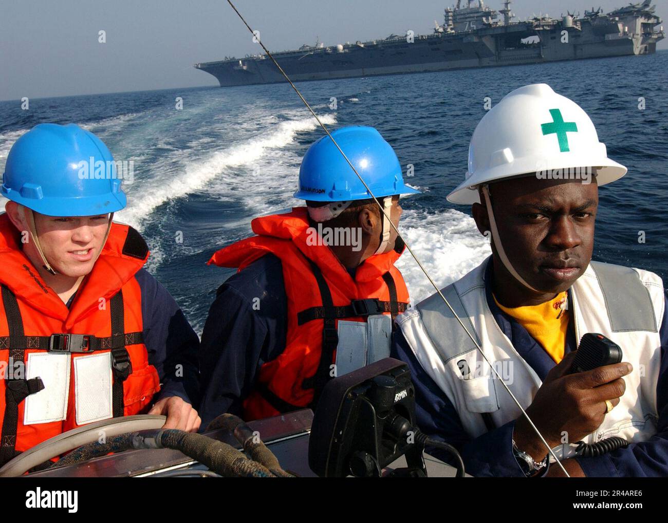 US Navy Boat Officer Lt.j.g. right, maintains communication with the ...