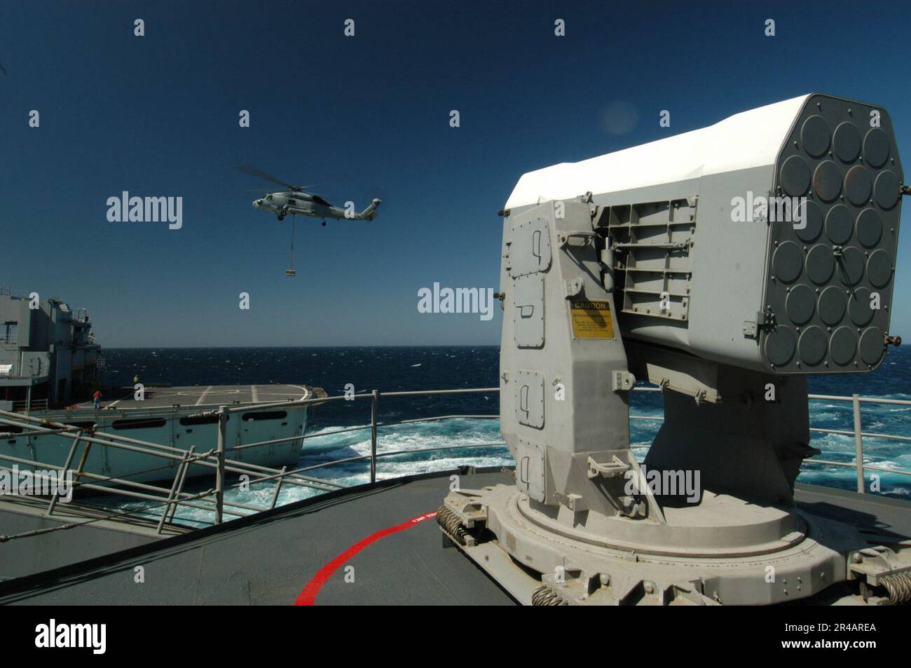 US Navy An SH-60B Seahawk delivers a pallet of ordnance to the Military ...