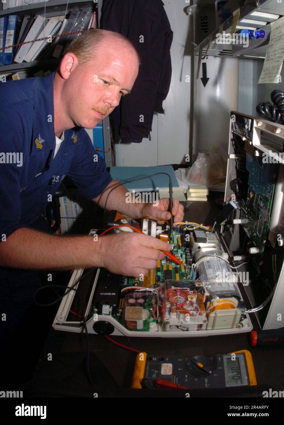 US Navy Hospital Corpsman 1st Class checks the power inputs on a ...