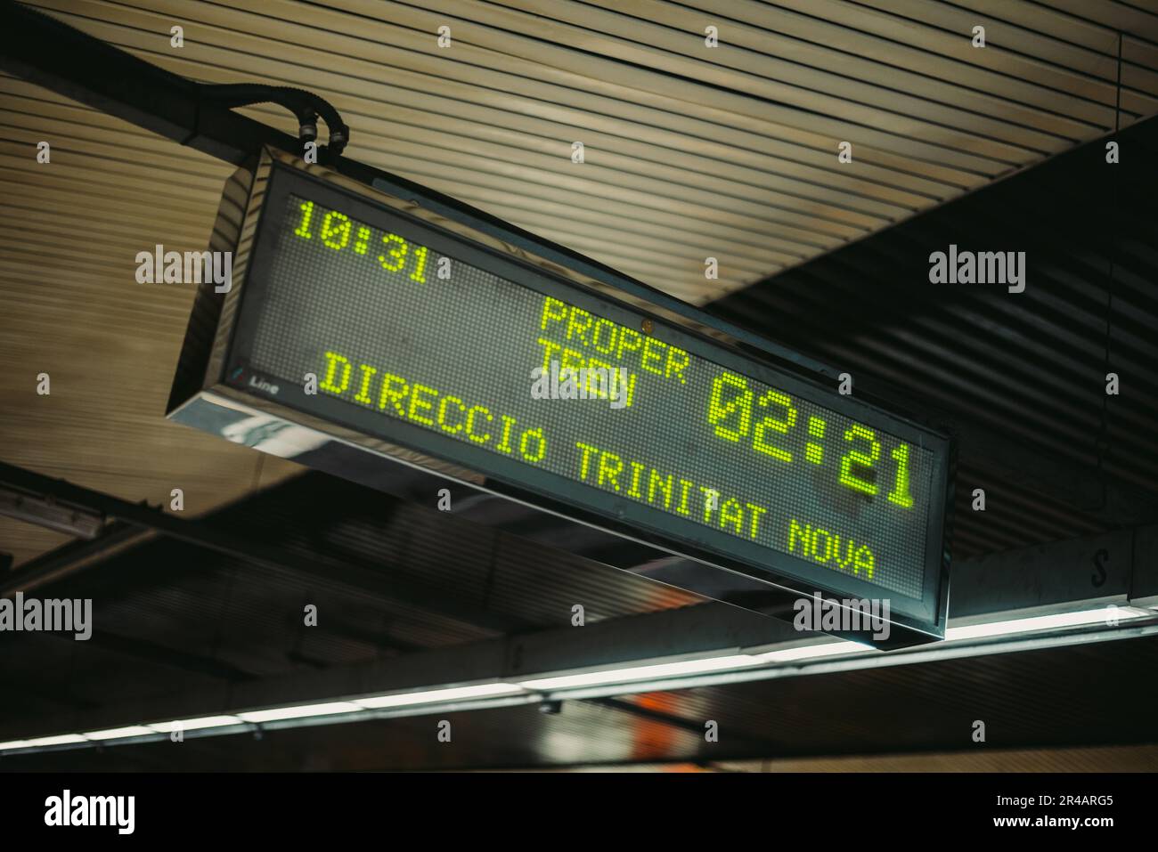 A vibrant green neon sign displaying train timetable in Spain Stock ...