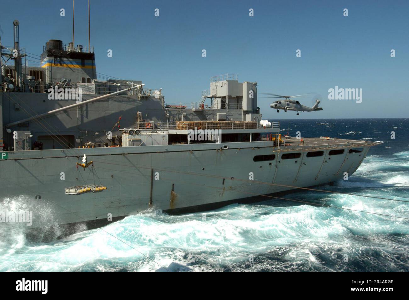 US Navy An SH-60B Seahawk delivers a pallet of ordnance to the Military ...