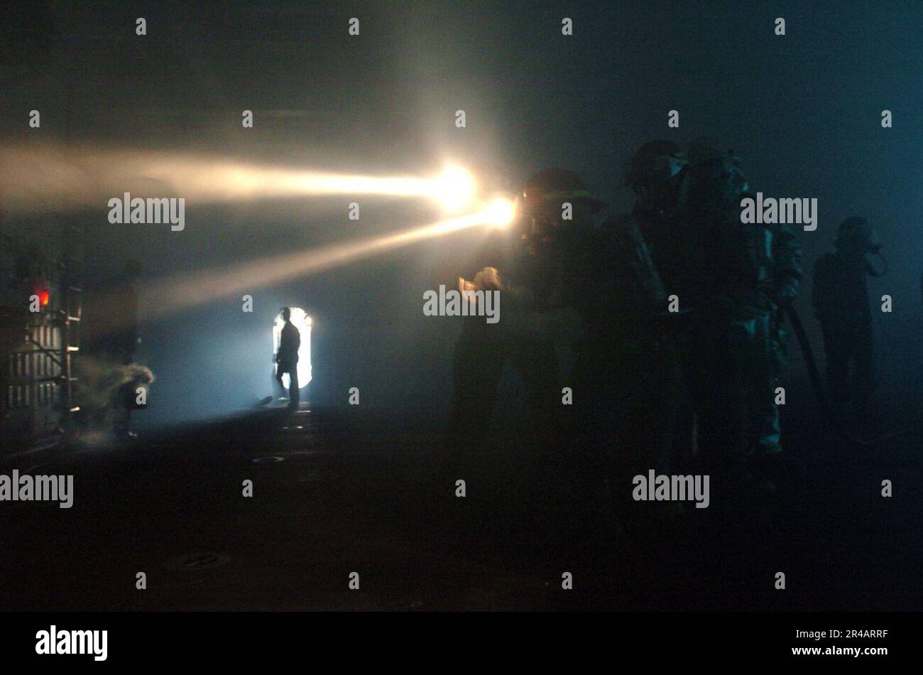 US Navy A fire fighting team works in the darkness to put out a ...