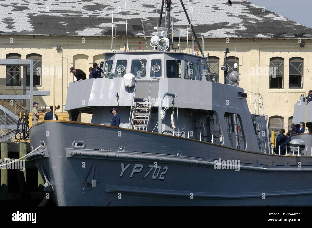 US Navy Crew members aboard yard-patrol boat YP702 make preparations to ...