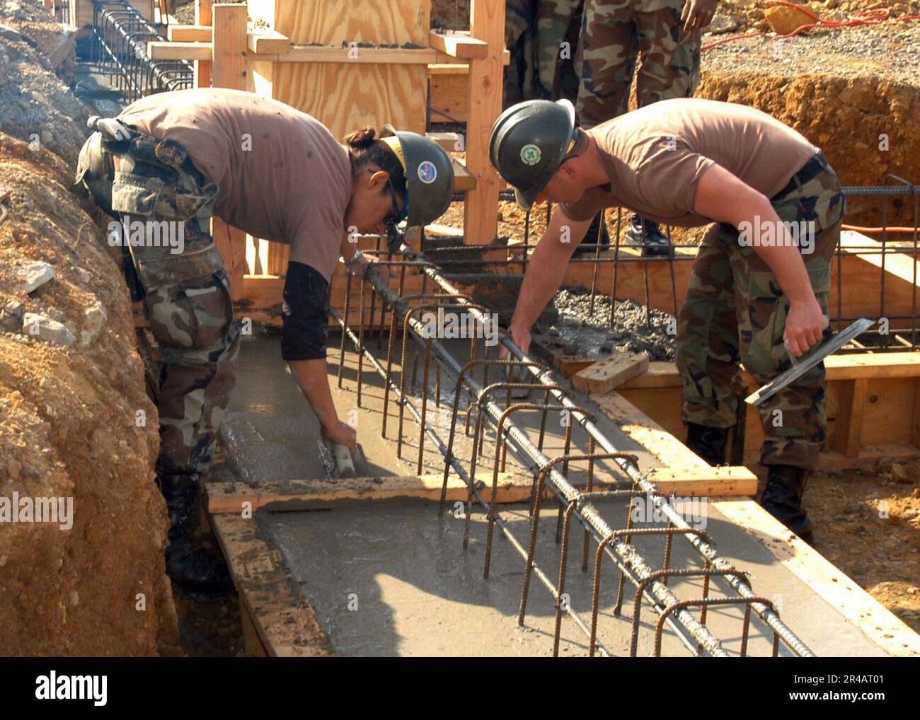 US Navy Builder 3rd Class left, and Steelworker 3rd Class use a ...