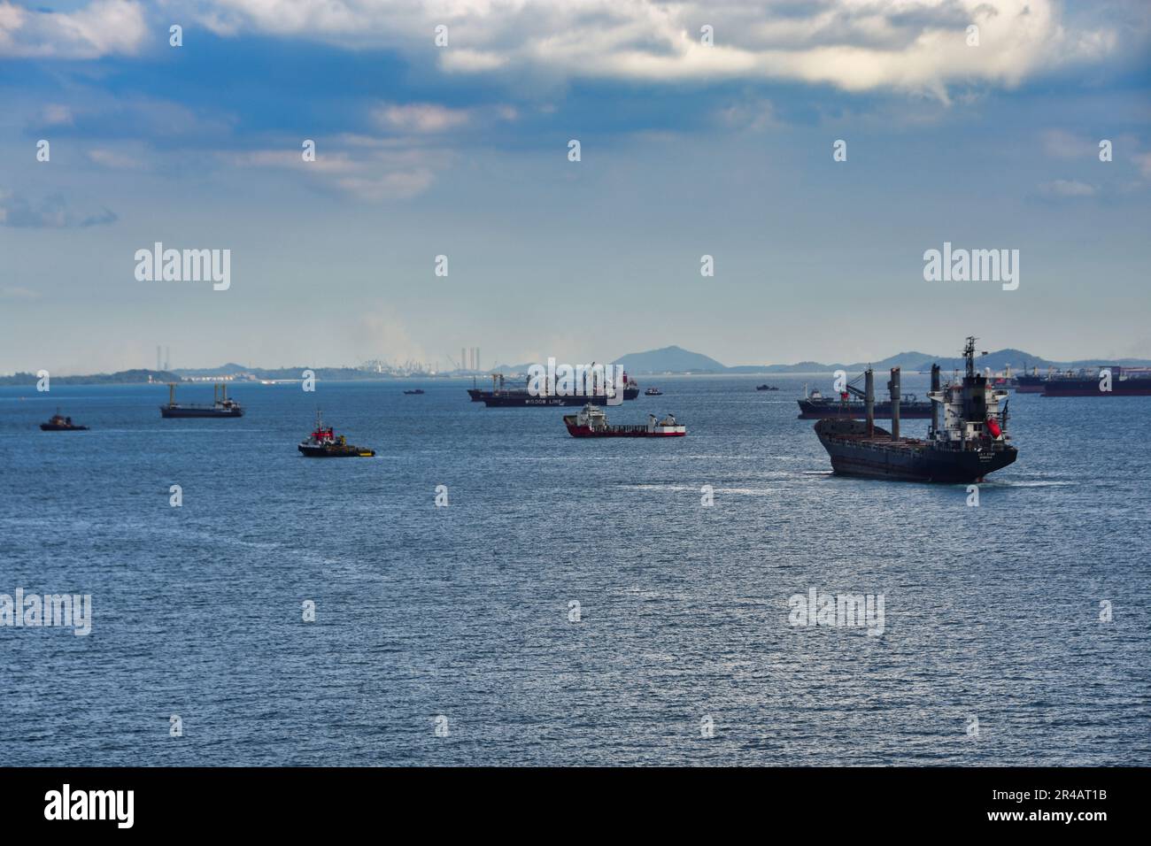 A fleet of container ships sailing on the open sea near Singapore Stock ...