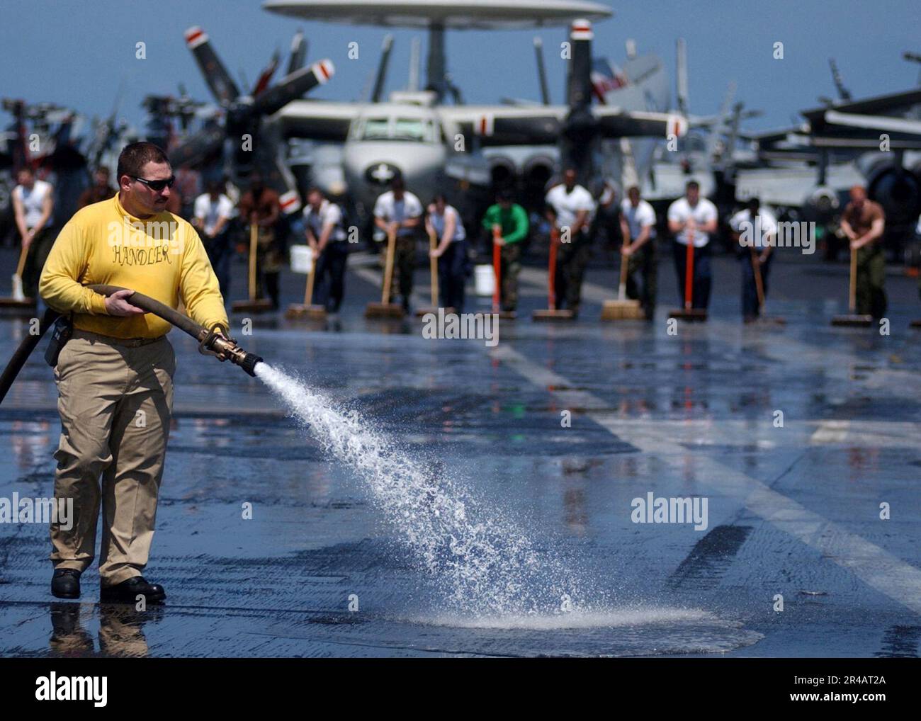 US Navy USS Harry S. Truman (CVN 75) Handler, Lt. Cmdr. sprays down the ...
