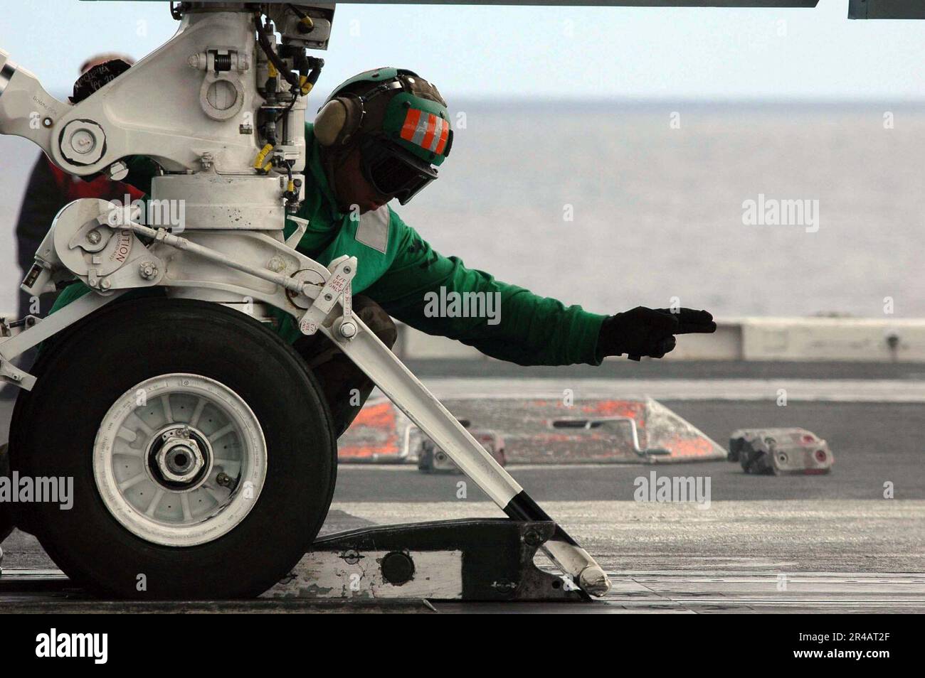 US Navy Aviation Boatswain's Mate 3rd Class prepares an E-2C Hawkeye ...