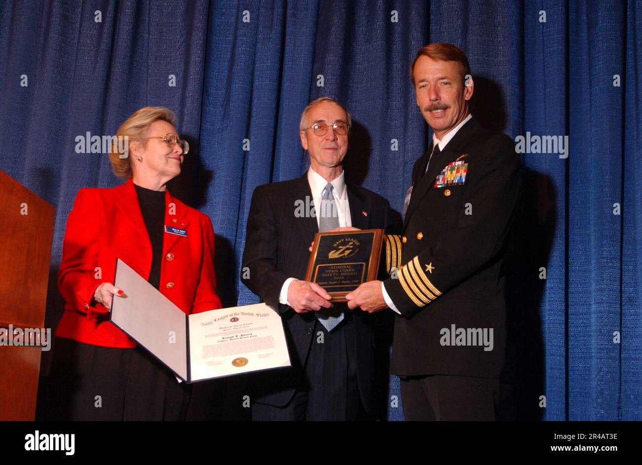US Navy Capt. Joseph J. Paulis, right, is honored for his work as ...