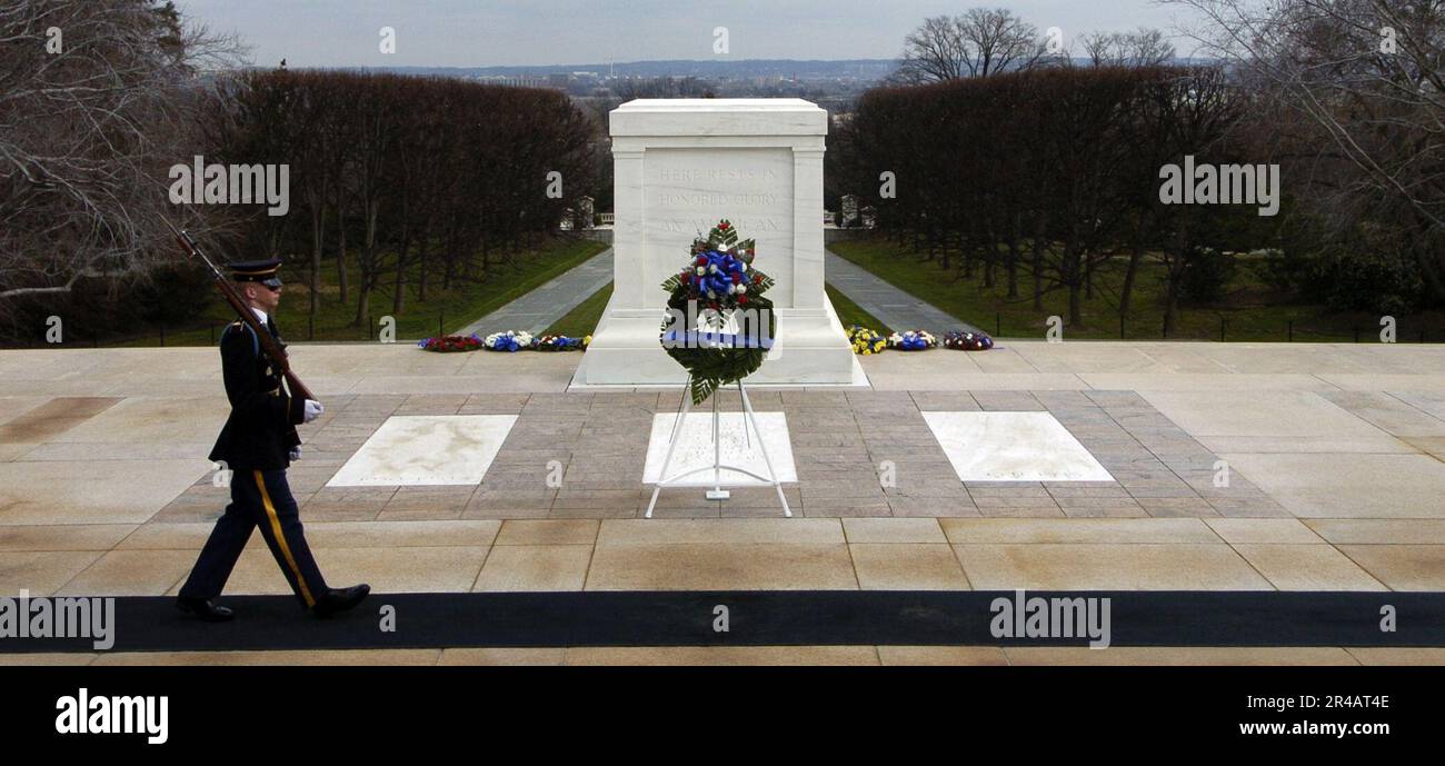 US Navy Tomb Guard Pfc. marches 21 steps down the black mat behind the ...