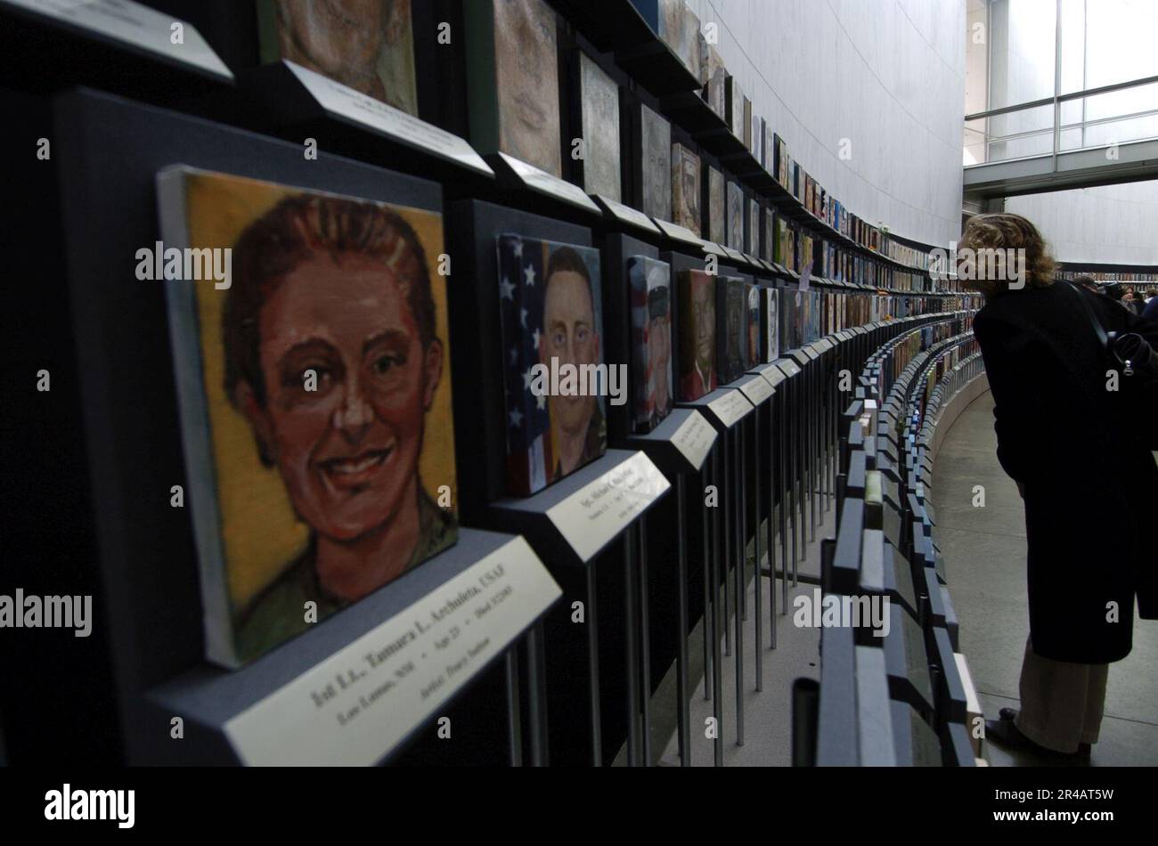 US Navy A woman looks at one of more than 1,300 portraits that make up ...