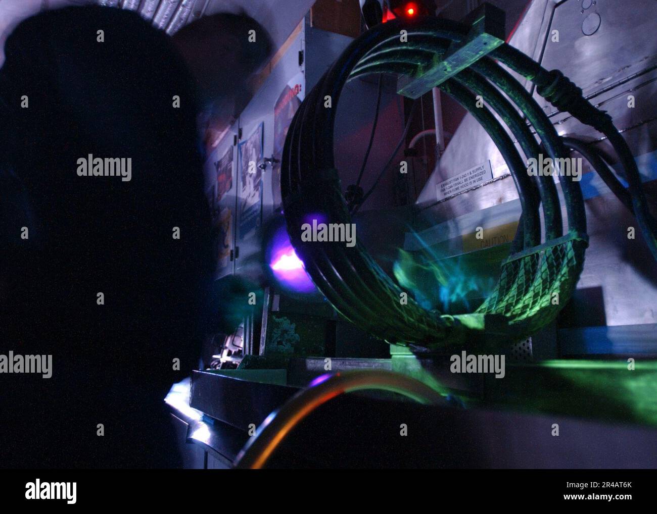 US Navy Aviation Machinist's Mate 2nd Class uses a black light to ...