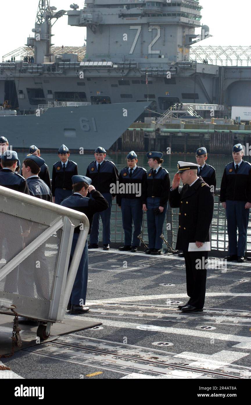 US Navy Officer of the Deck, Ens. right, accepts the salute of a Royal ...
