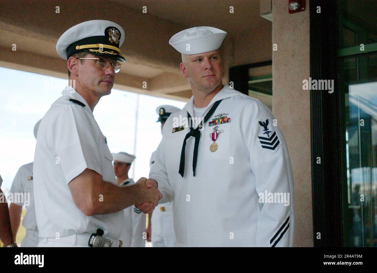 US Navy Capt. shakes the hand of Hospital Corpsman 1st Class at an ...