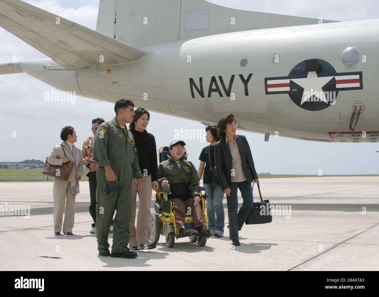 US Navy Lt.j.g. left, gives a tour of a P-3C Orion, assigned to the ...