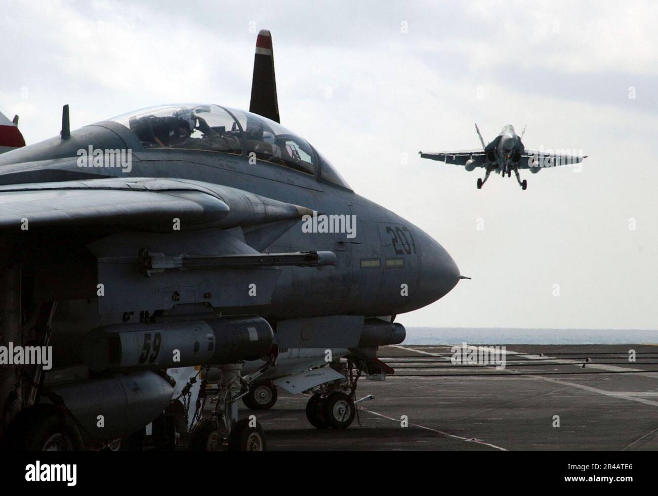 US Navy The aircrew in an F-14D Tomcat watch as an F-A-18C Hornet lands ...