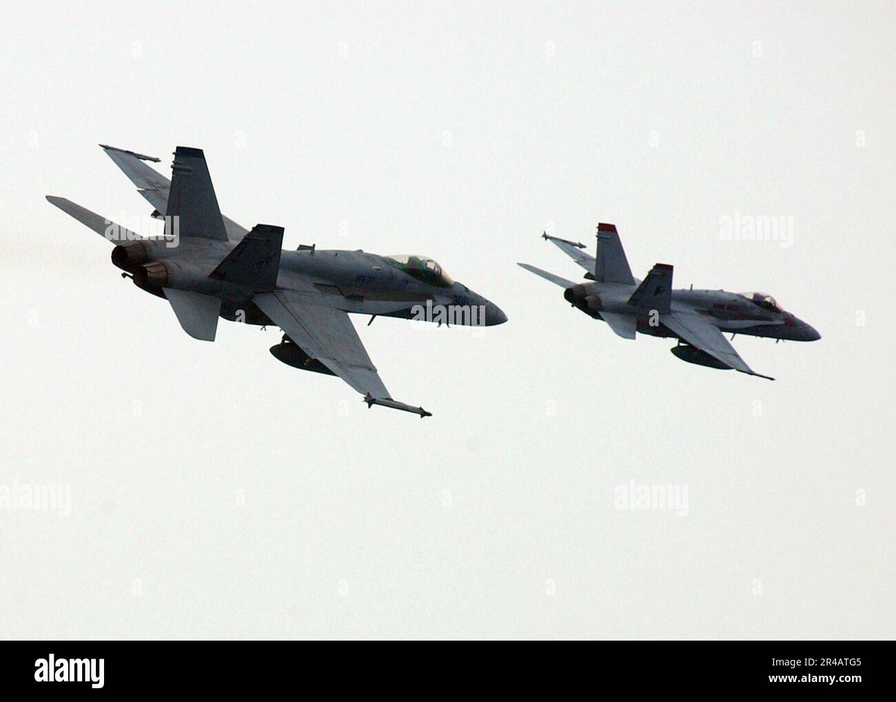 US Navy Two F-A-18C Hornets perform a fly-by during the squadron's ...