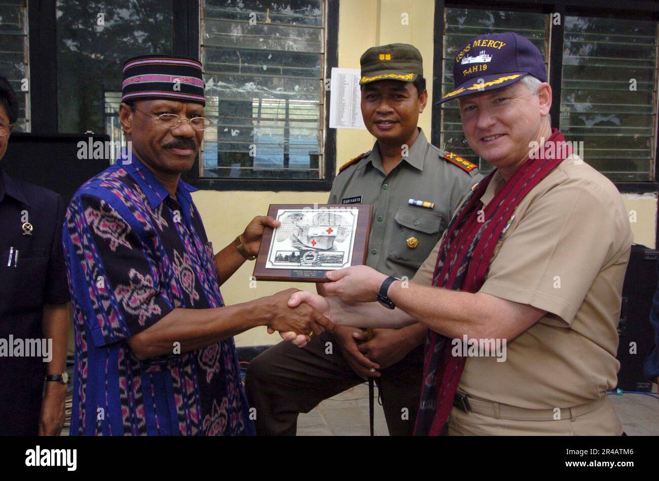 US Navy Commander, Task Group 73.1, Commodore Timothy McCully, presents ...
