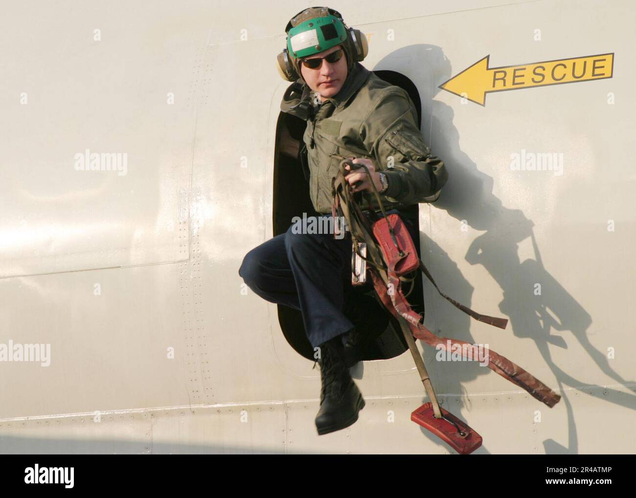 US Navy Aviation Electronics Technician 2nd Class prepares to cover the ...