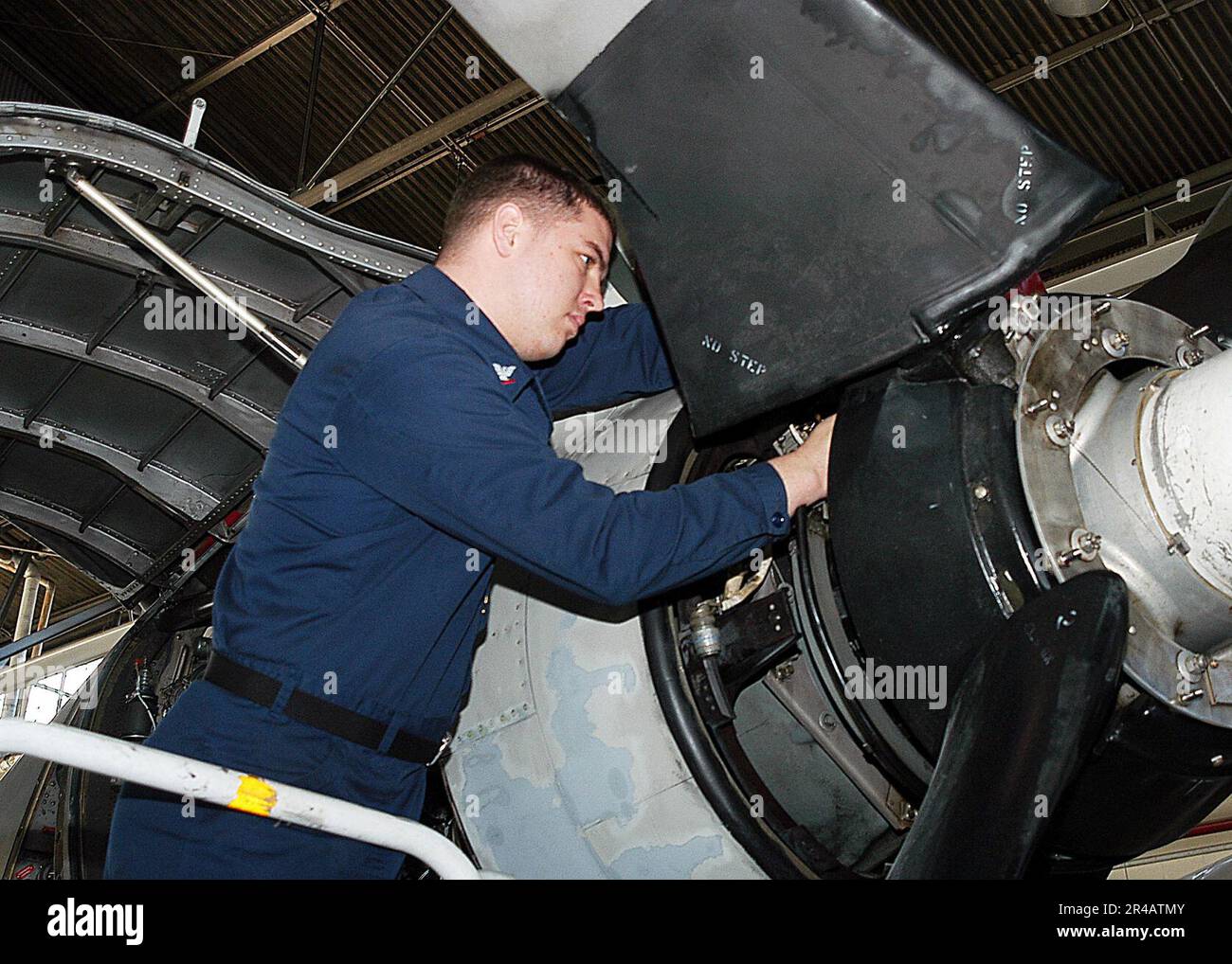 US Navy Aviation Electrician 3rd Class changes a pulse generator magnet ...