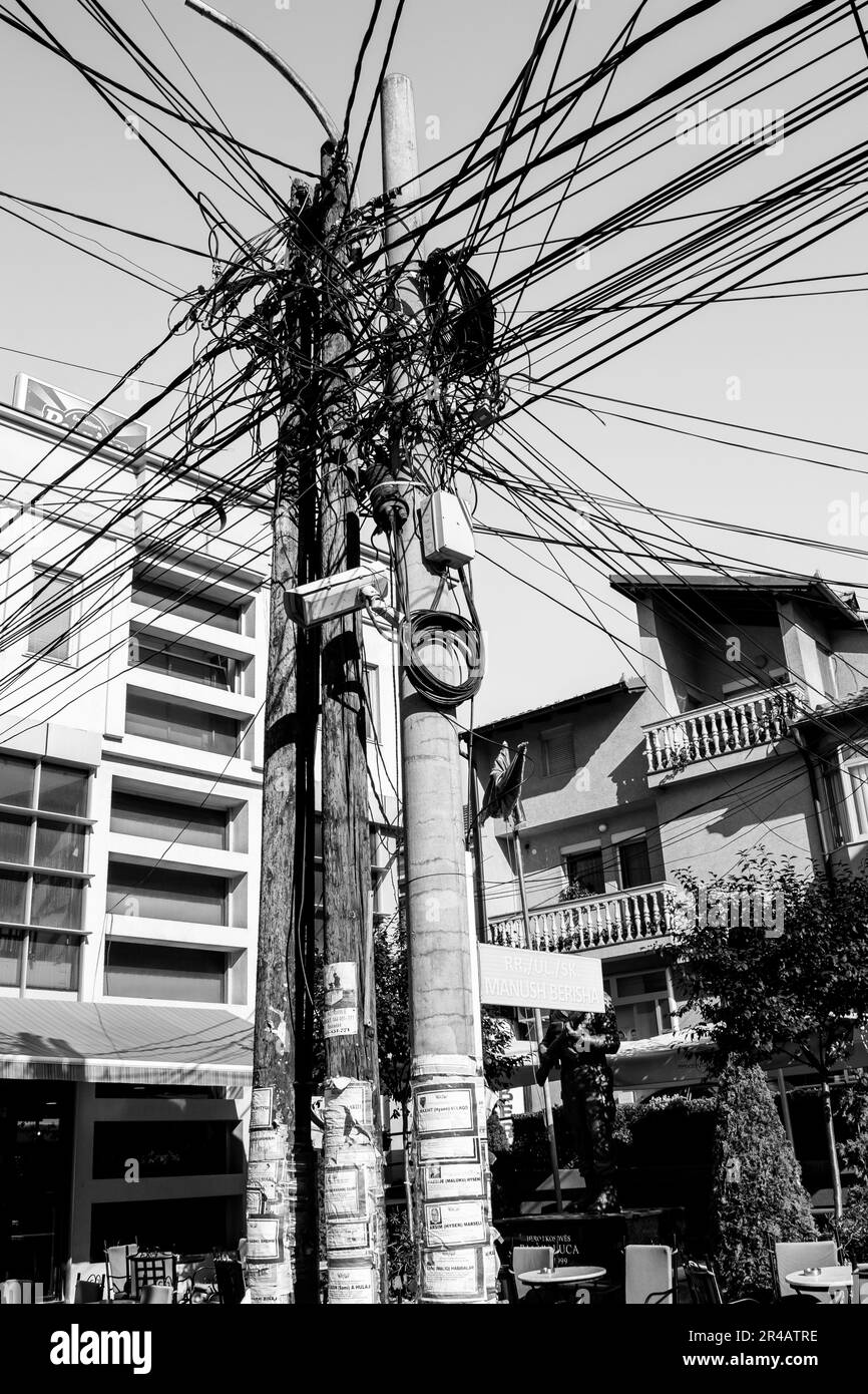 A tangled mass of electricity wires and power cables stuck to a street ...