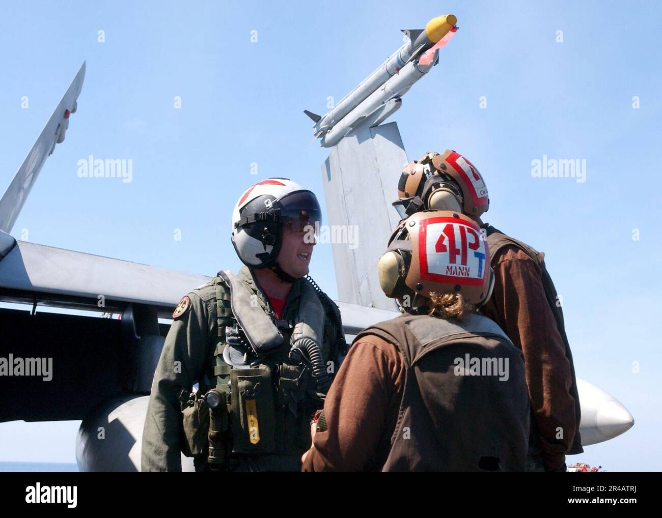 US Navy A Naval Aviator receives a briefing from his Plane Captains at ...