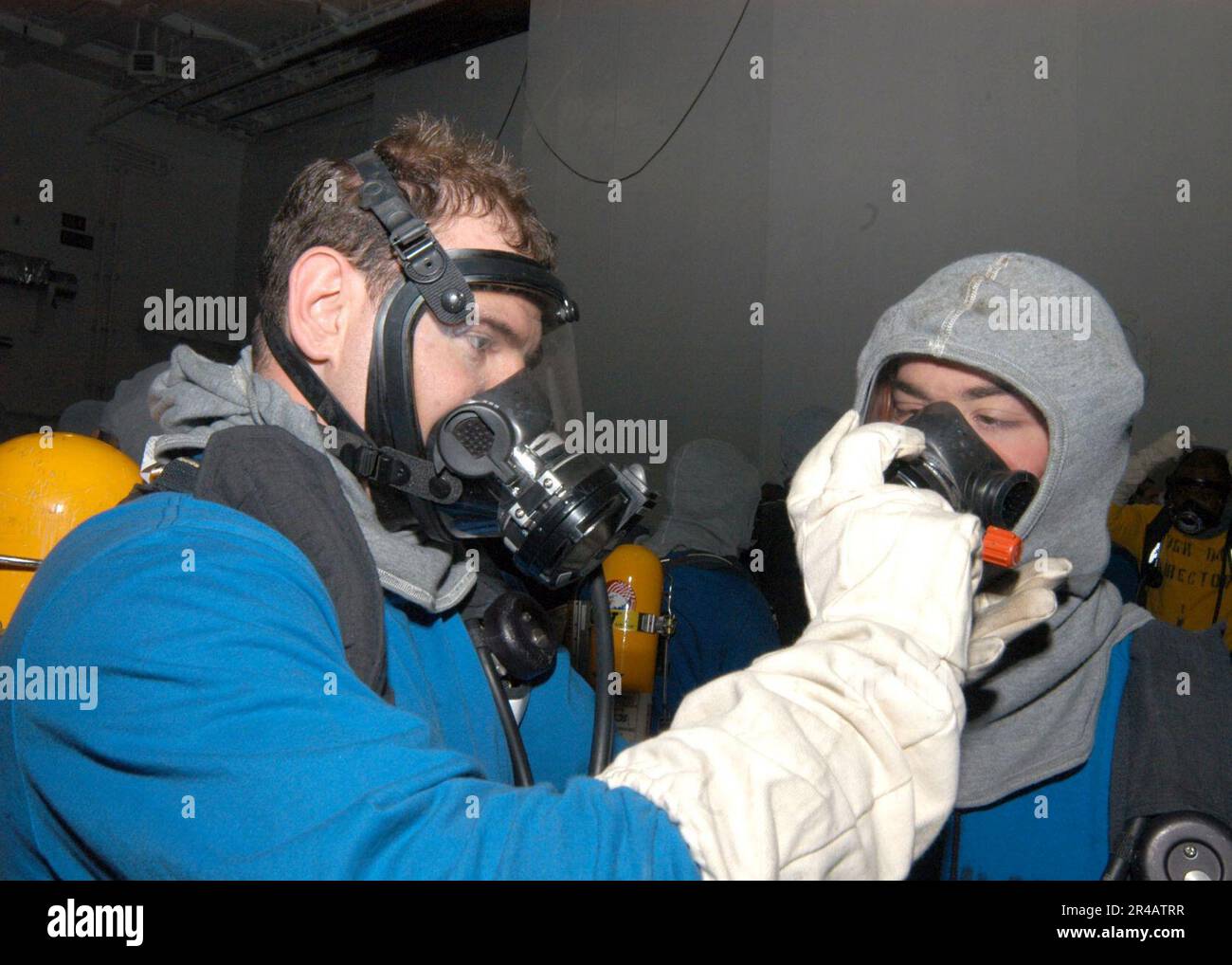US Navy Airman left, helps a shipmate connect the second stage ...