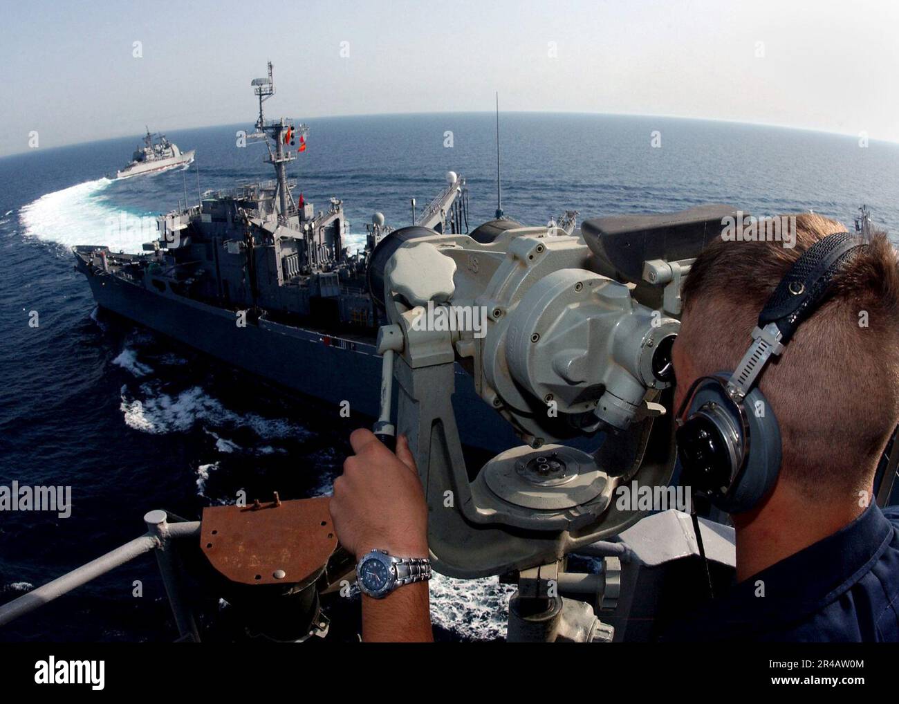 US Navy Boatswain's Mate Seaman looks through the big eyes binoculars ...