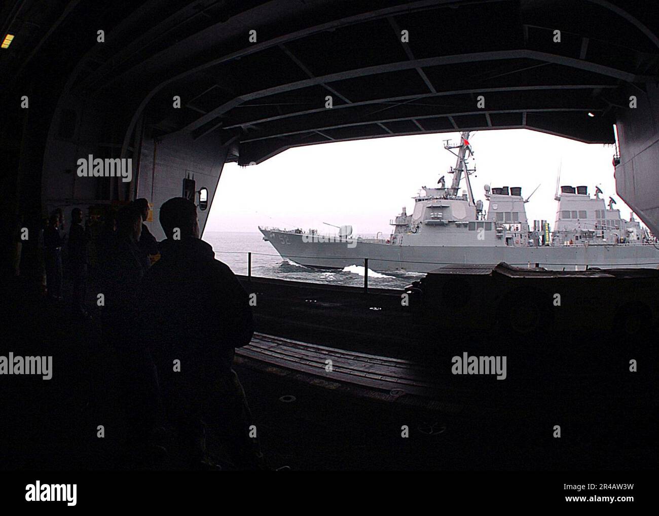 US Navy The Arleigh Burke-class guided missile destroyer USS Barry (DDG 52) cruises along side ...