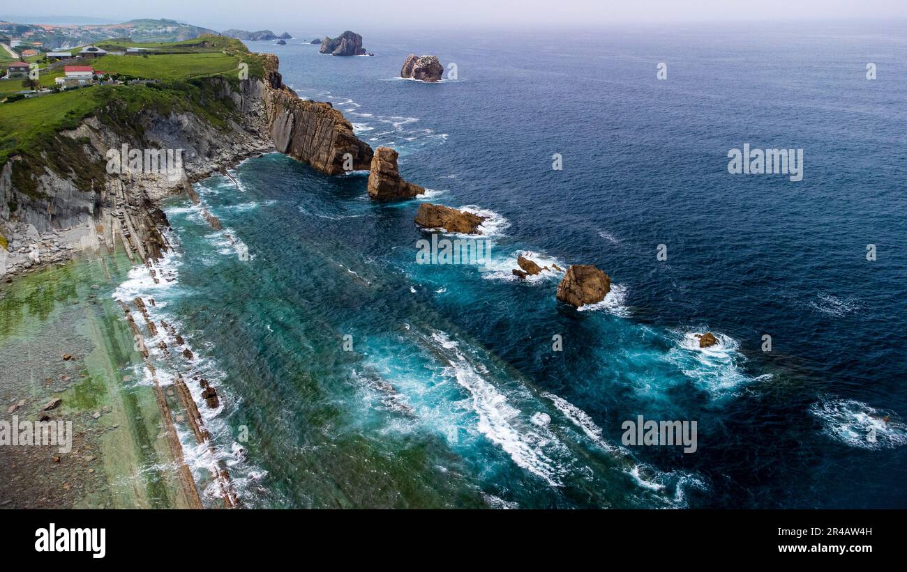 Stunning coastal formation featuring towering rock pillars rising from ...