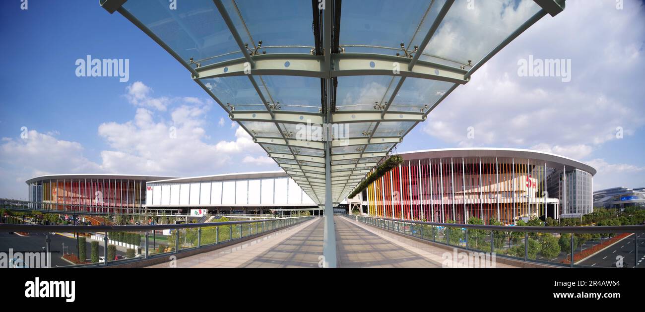 A busy airport terminal is seen with a bridge leading to the entrance ...