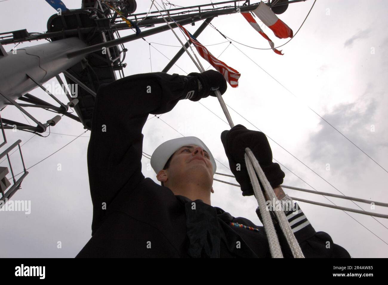 US Navy Personnelman Seaman shifts colors and raises the National ...