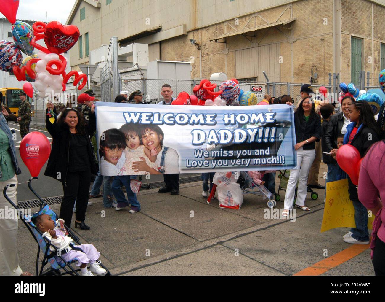 US Navy Friends and family await their Sailors and Marines to disembark ...