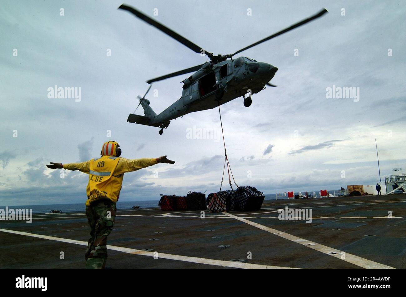 US Navy A Landing Signal Enlisted Sailor guides an MH-60S Seahawk ...