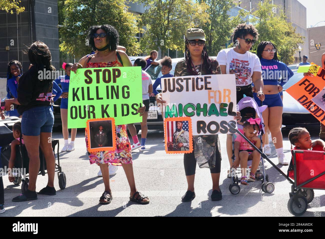 A group of African American people marching in a parade, holding ...