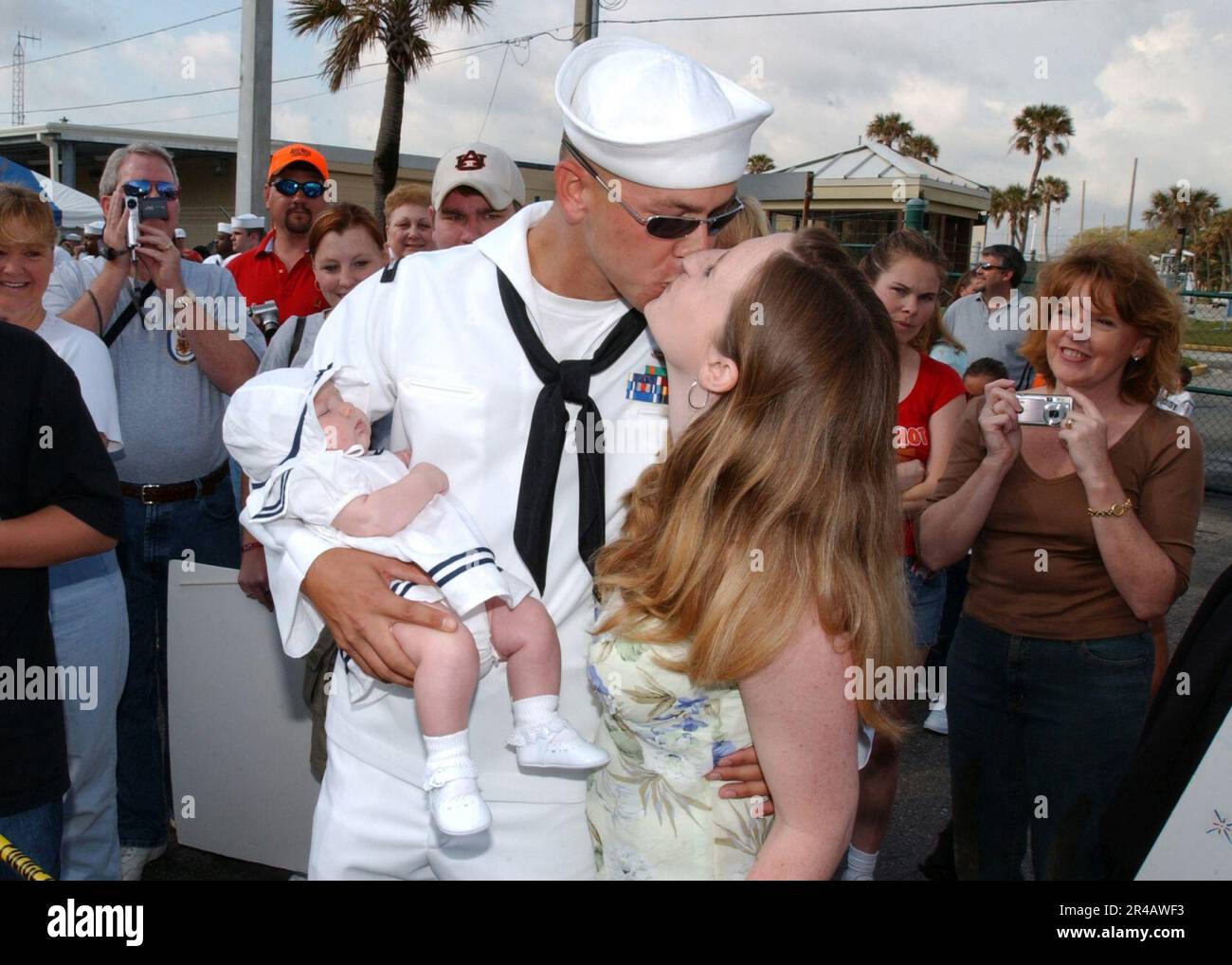 US Navy Fire Controlman 2nd Class embraces his new son with wife for ...
