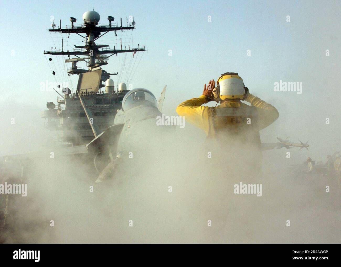 US Navy An aircraft director signals an F-A-18C Hornet, assigned to the ...