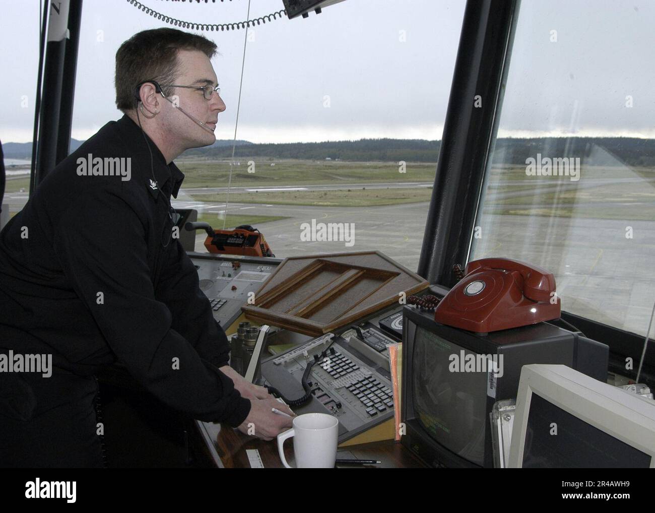 US Navy Air Traffic Controller 3rd Class scans the air field from the ...