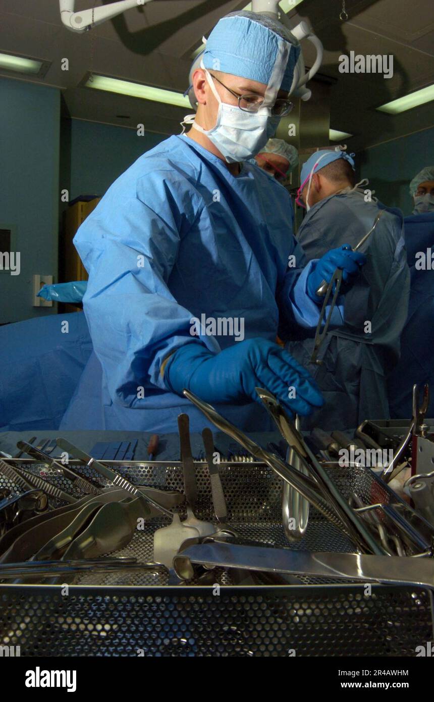 US Navy Hospitalman organizes operating tools used by the medical ...