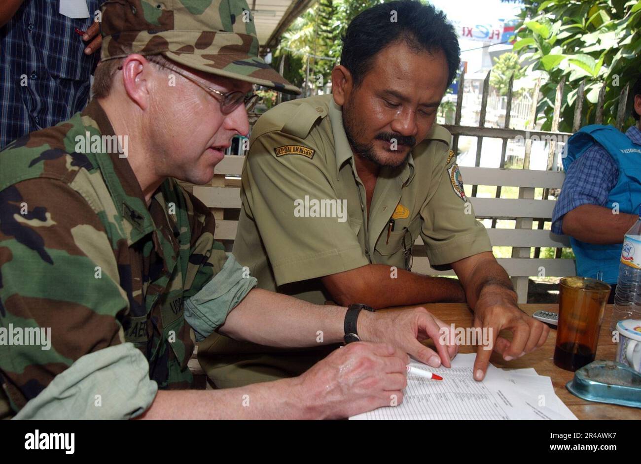 US Navy U.S. Public Health Services Capt. left, reviews medical care ...